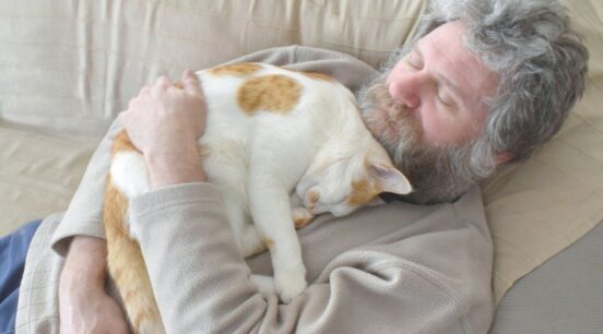 Why Your Cat Sleeps Pressed Up Against You & What It Really Means ...